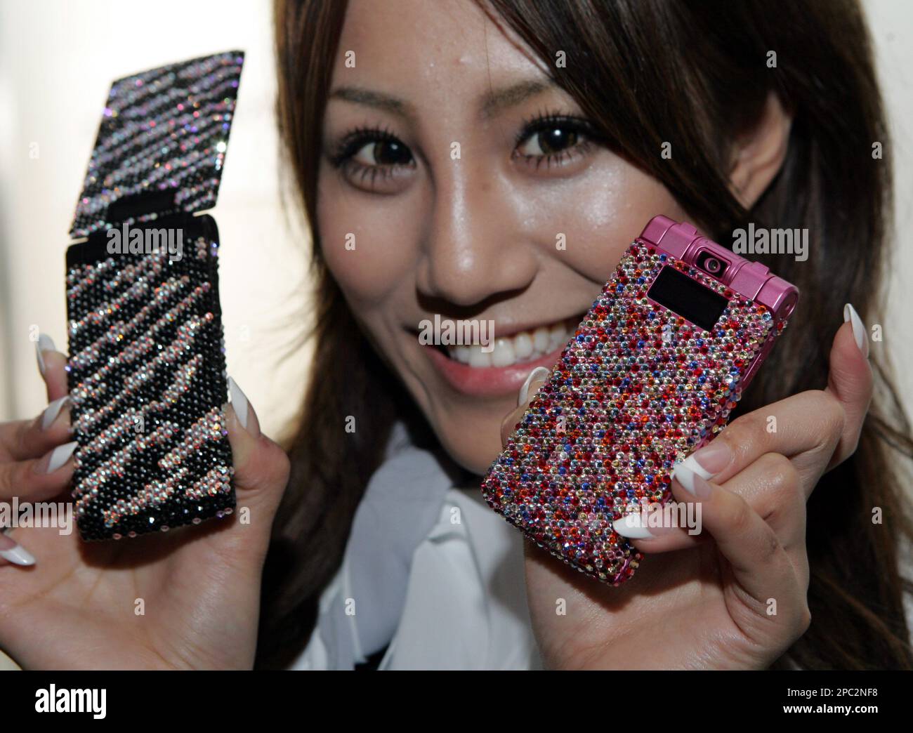 A model displays Softbank's new mobile phone the 707SC in Tokyo ...