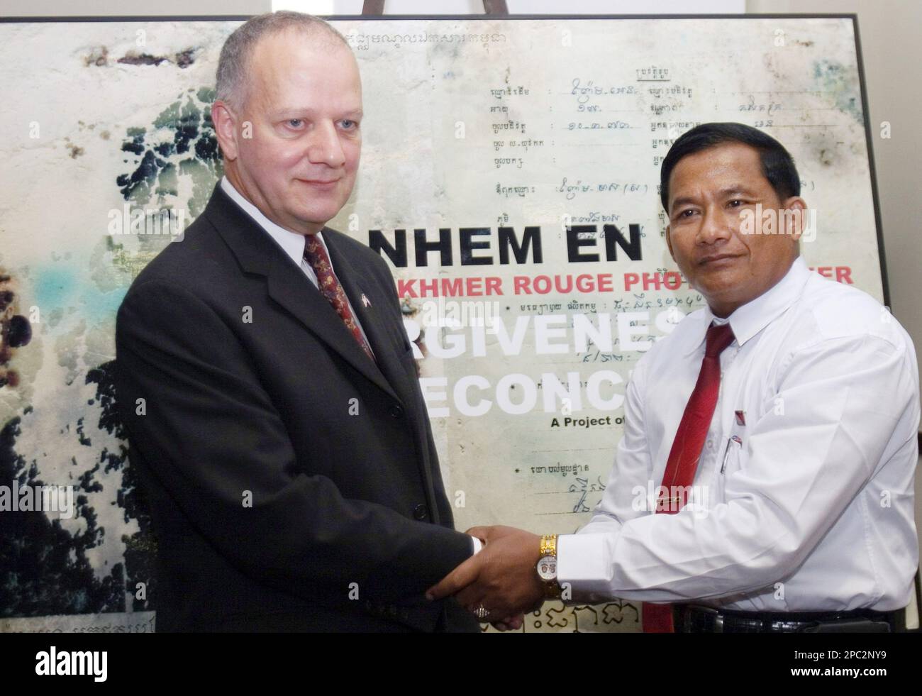 U.S. Ambassador to Cambodia, Joseph Mussomeli, left, shakes hands with ...
