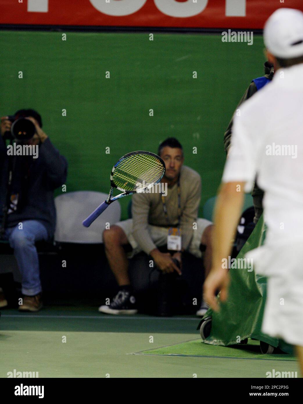 The tennis racket of Andy Roddick of the U.S. flies across the court ...