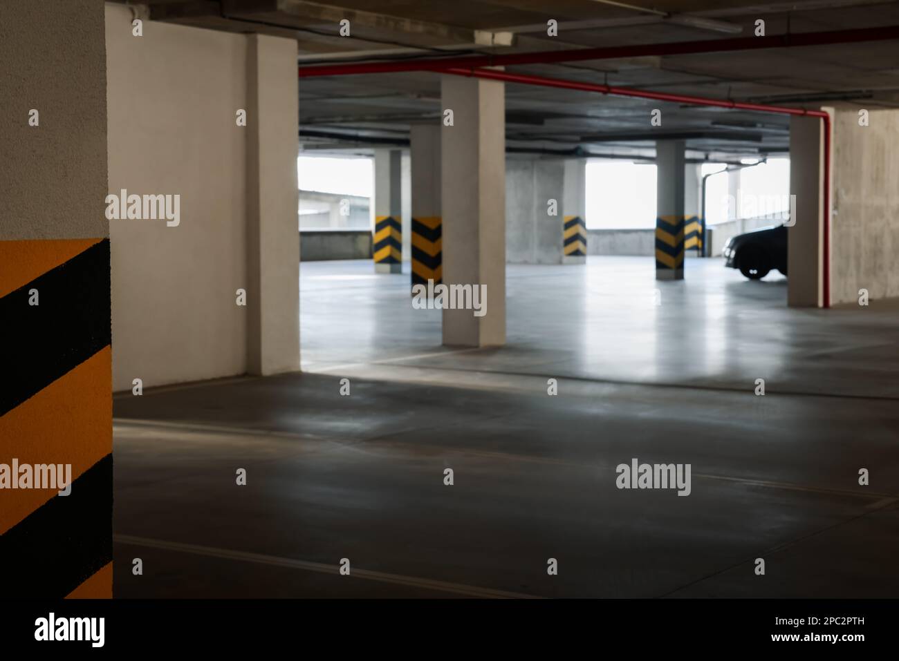 Open car parking garage, focus on column with warning stripes Stock ...