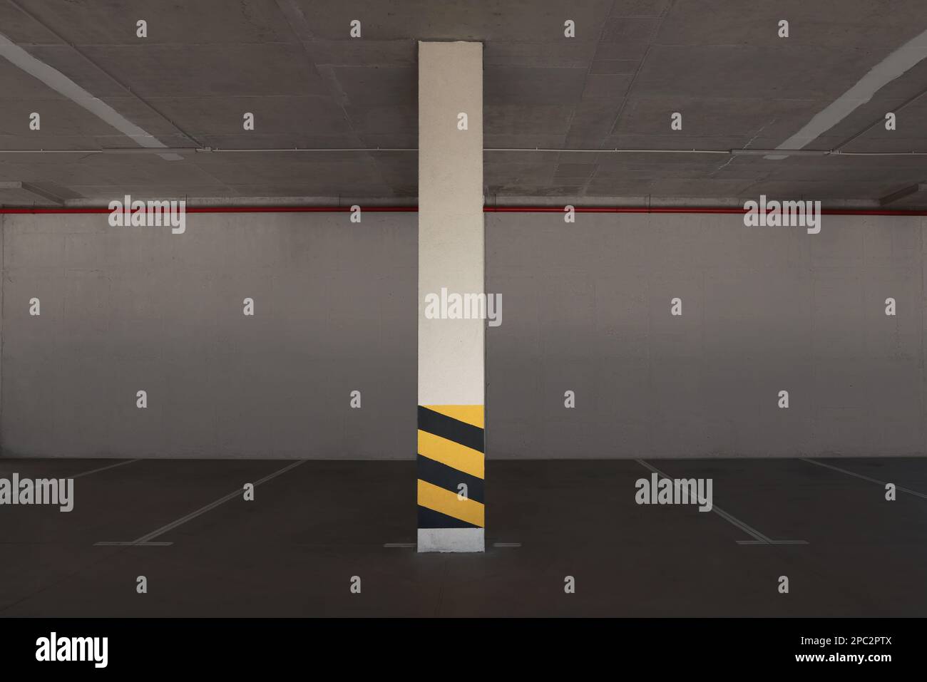 Empty car parking garage with warning stripes on column Stock Photo - Alamy