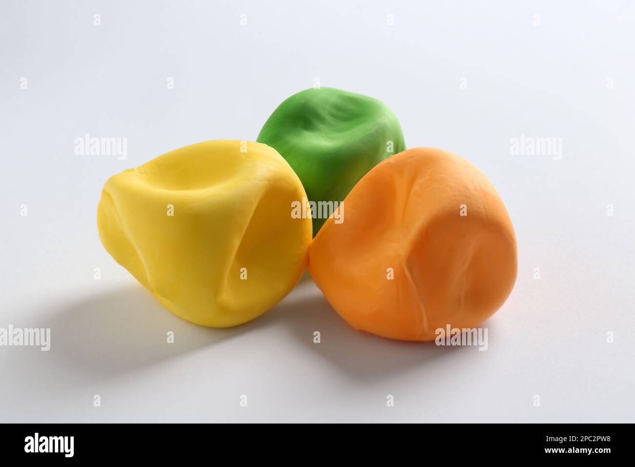 Different color play dough on white background Stock Photo - Alamy