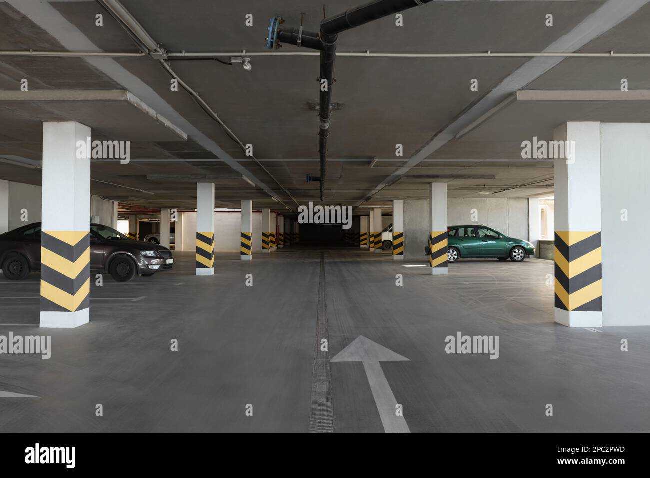 Open parking garage with cars and empty slots Stock Photo - Alamy
