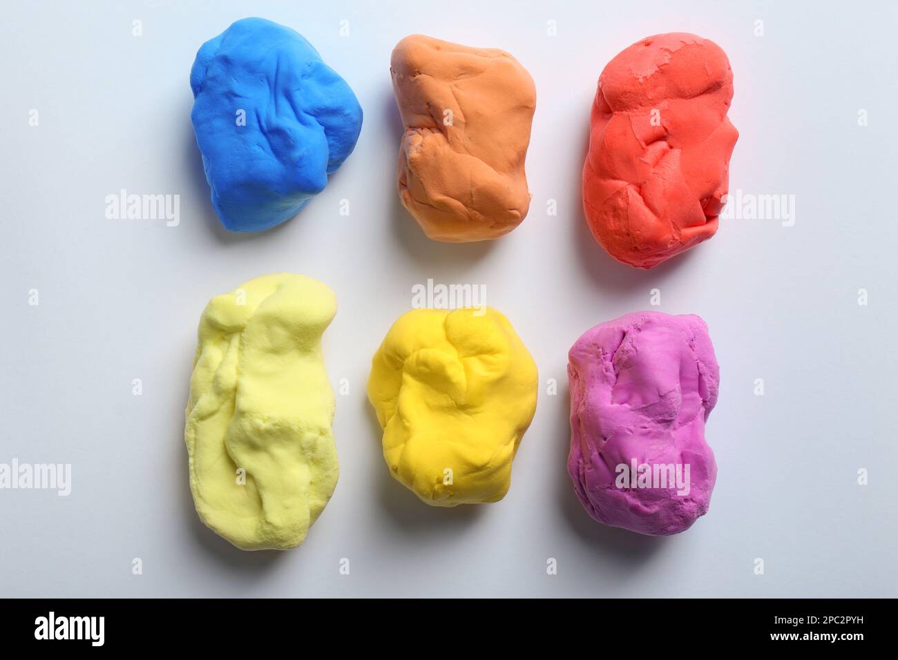 Different color play dough on white background, top view Stock Photo ...