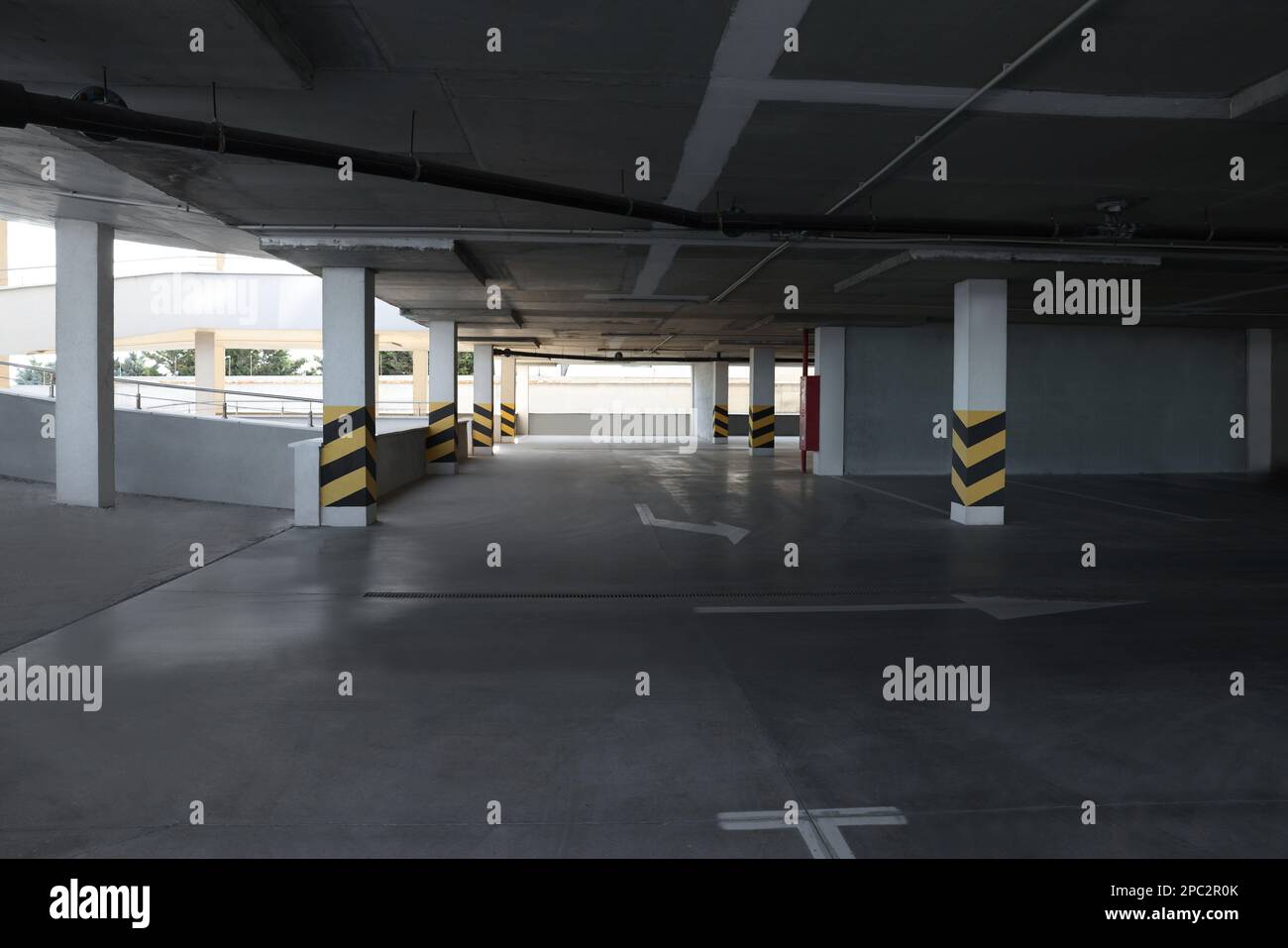Empty open car parking garage with warning stripes on columns Stock ...