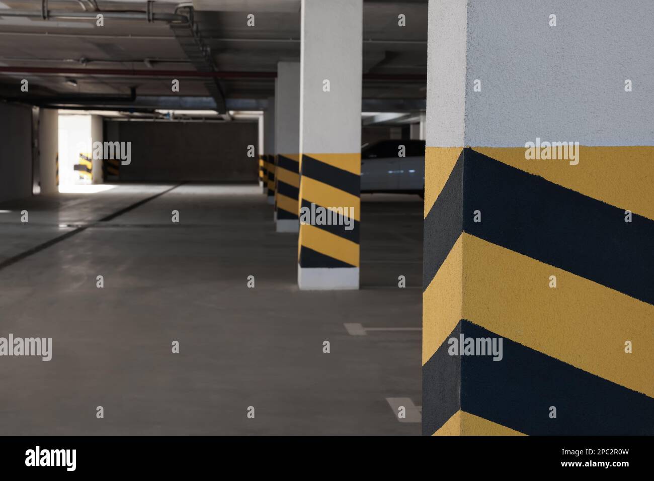 Car parking garage with warning stripes on columns Stock Photo - Alamy