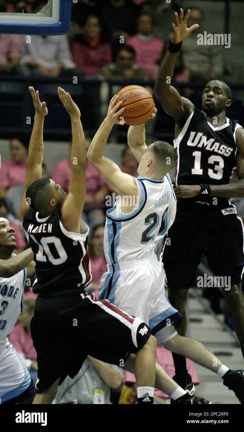 Rhode Island guard Jimmy Baron (20) attempts a shot through the defense ...