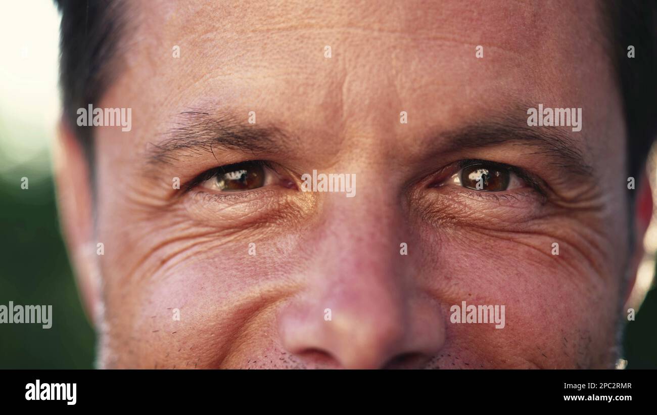 Macro eyes of a happy man looking at camera. Close up of male 40s ...
