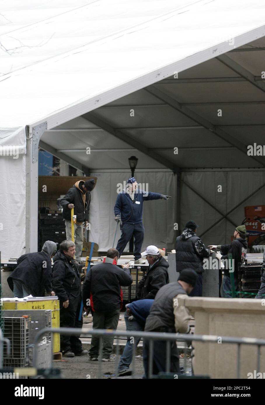 Workmen install tents in Bryant Park in preparation for Fashion Week in ...