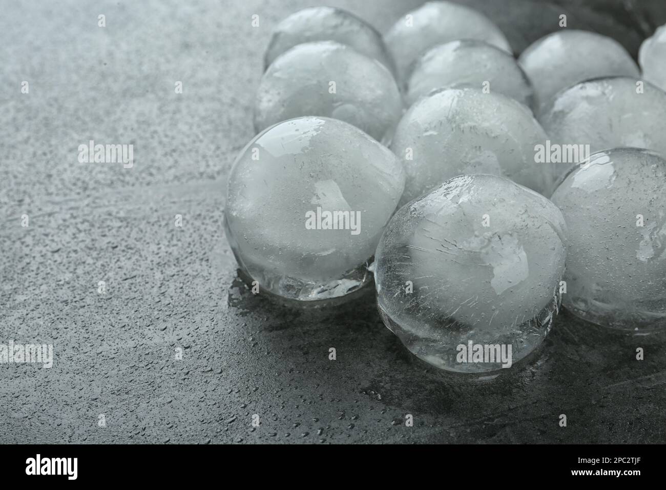 Many frozen ice balls on dark grey table, closeup. Space for text Stock ...