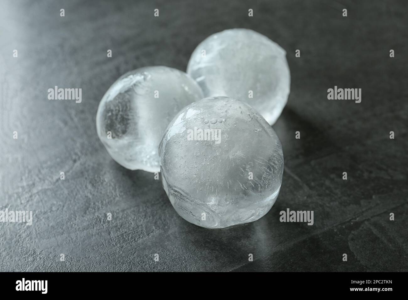 Frozen ice balls on dark grey table Stock Photo - Alamy
