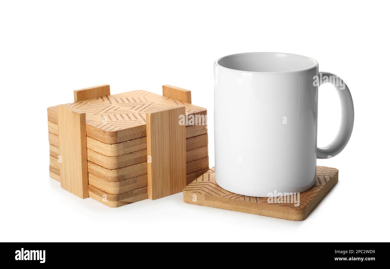 Mug and stylish wooden coasters on white background Stock Photo - Alamy