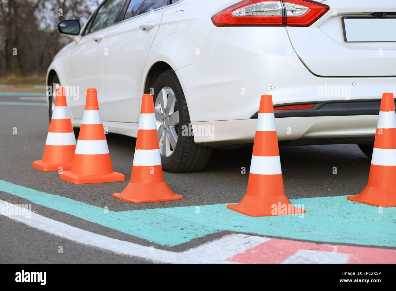 Modern car on driving school test track with traffic cones Stock Photo ...