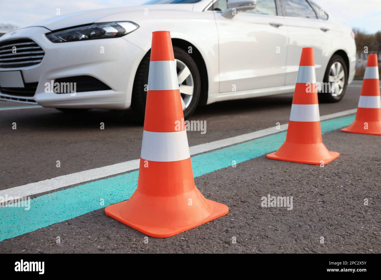Modern car at test track, focus on traffic cone. Driving school Stock ...