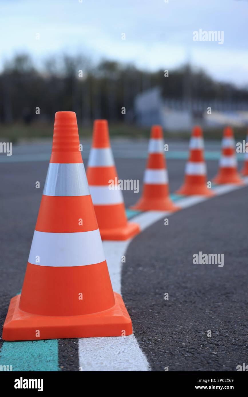 Driving school test track with marking lines, focus on traffic cone ...