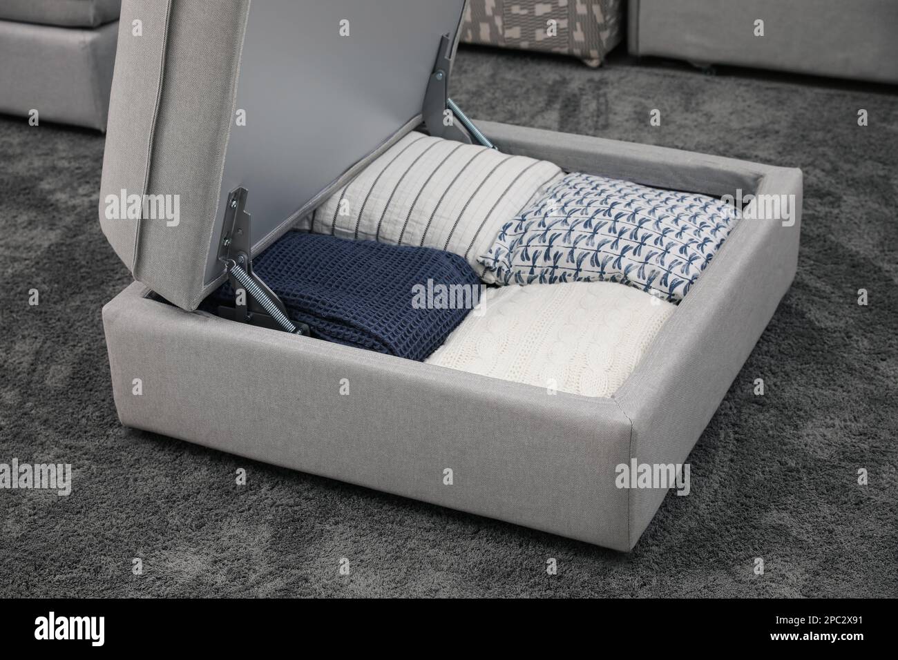 Open modular sofa section with storage in room Stock Photo - Alamy