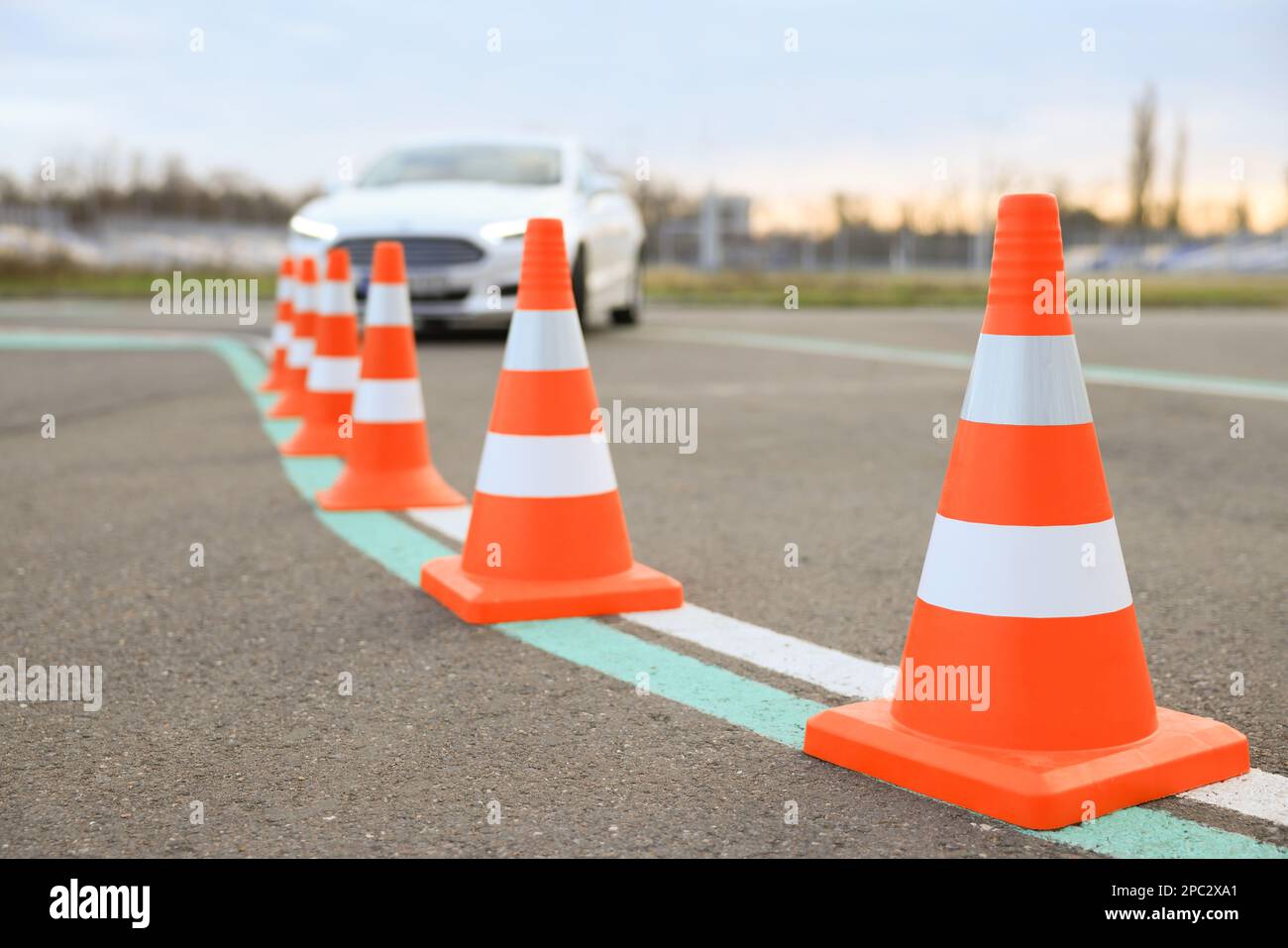 Modern car at test track, focus on traffic cone. Driving school Stock ...