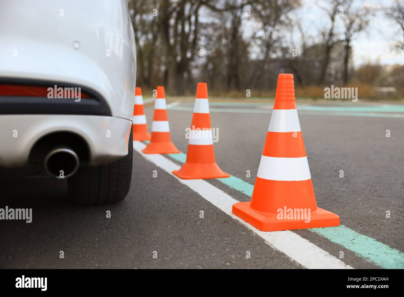 Modern car on test track with traffic cones, closeup. Driving school ...