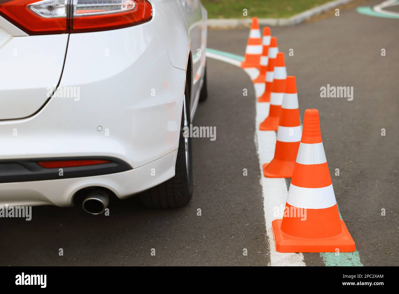 Modern car on test track with traffic cones, closeup. Driving school ...
