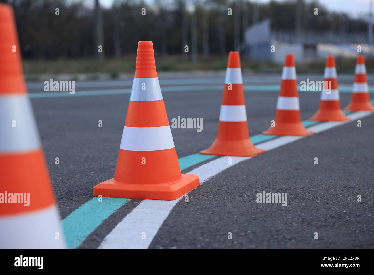 Driving school test track with marking lines, focus on traffic cone ...