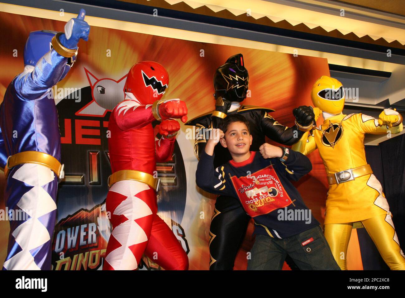 Walt Disney's Power Ranger cartoon characters pose with a school boy ...