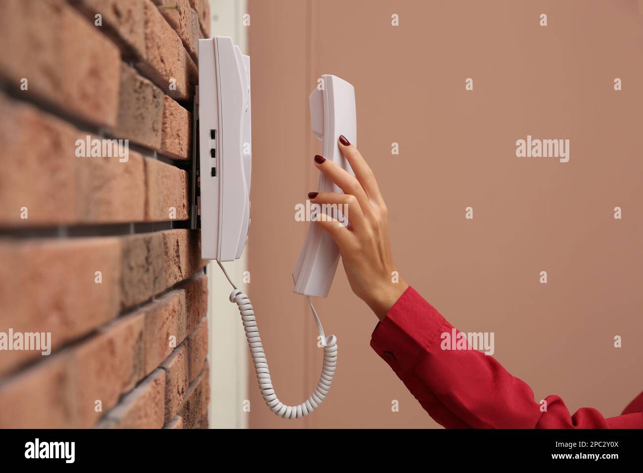 African-American woman answering intercom call indoors, closeup Stock ...
