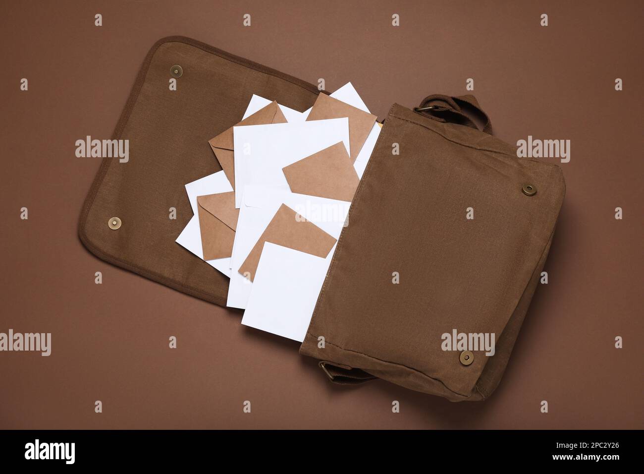Postman bag with mails on brown background, top view Stock Photo - Alamy