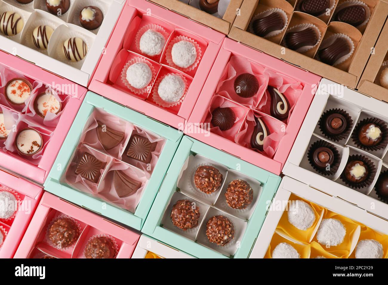 Many delicious candies in boxes, top view. Production line Stock Photo ...