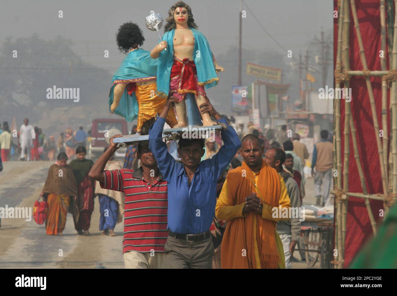 Devotees carry idols of Hindu Gods for immersion at Sangam, the ...