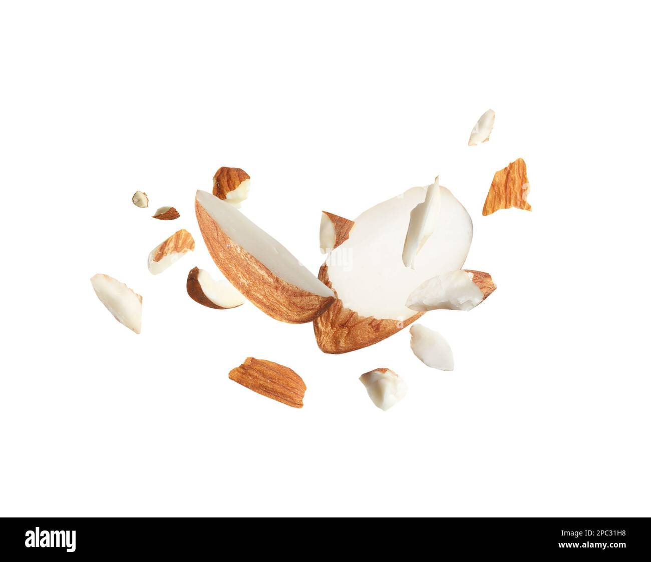 Pieces of tasty almonds falling on white background Stock Photo - Alamy