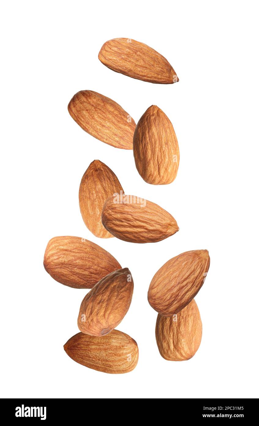 Many tasty almonds falling on white background Stock Photo - Alamy