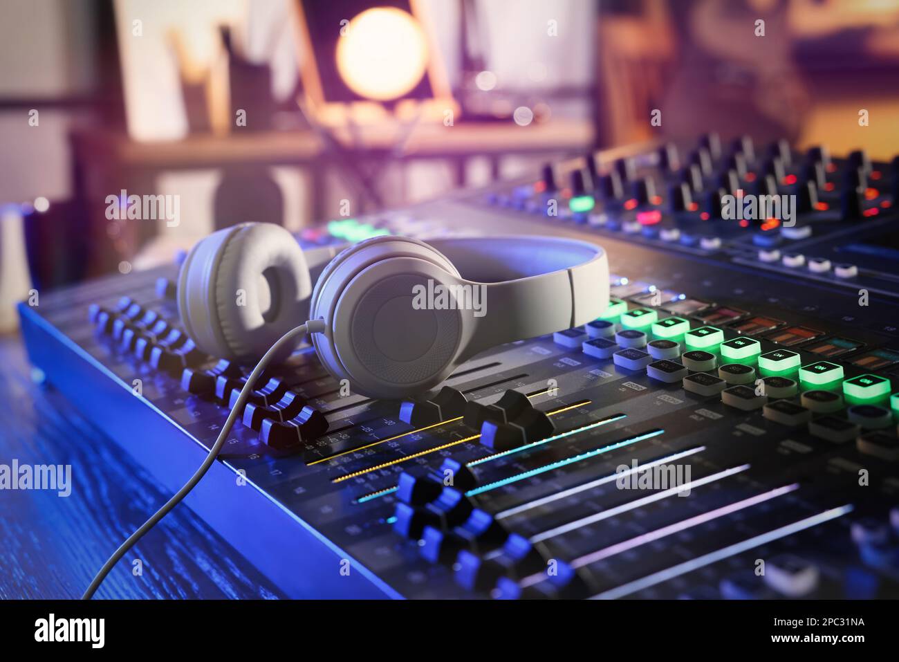 Professional mixing console with headphones on table in radio studio ...