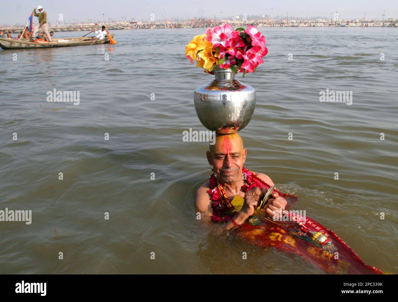 A Sadhu, or Hindu holy man, offers prayers at the Sangam, the ...