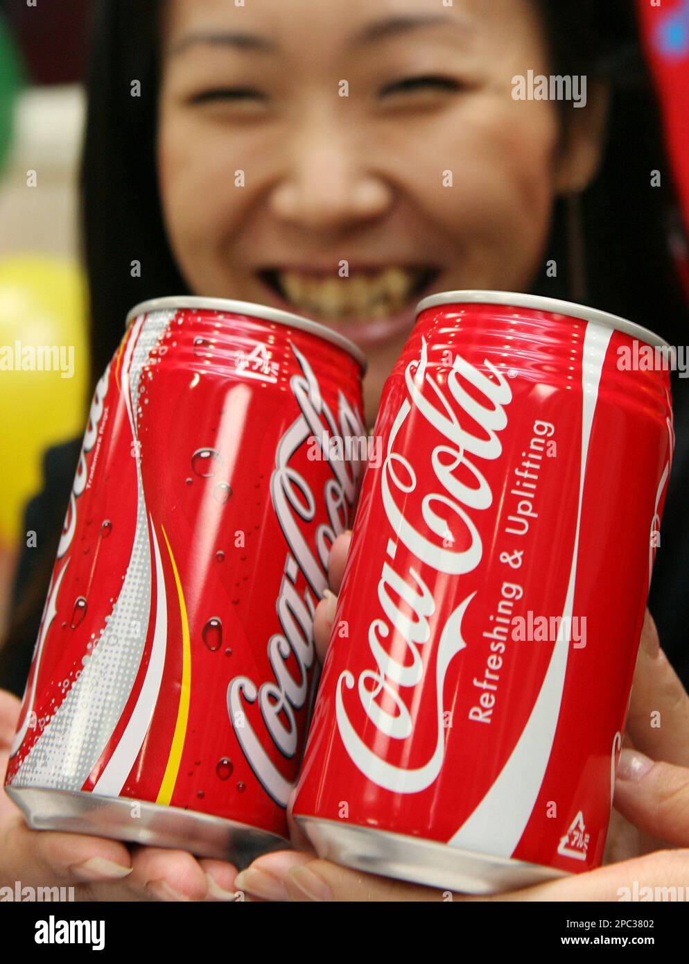 Coca-Cola Japan Co. employee Kayo Kobayashi shows off a newly designed ...