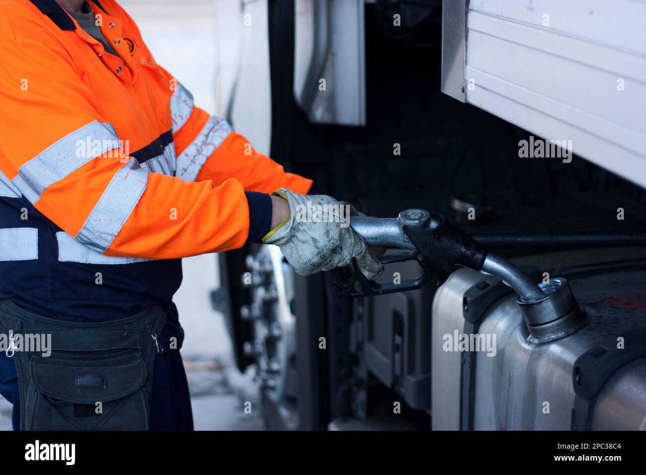 Man refueling diesel on big rig truck, truck driver refueling, global ...