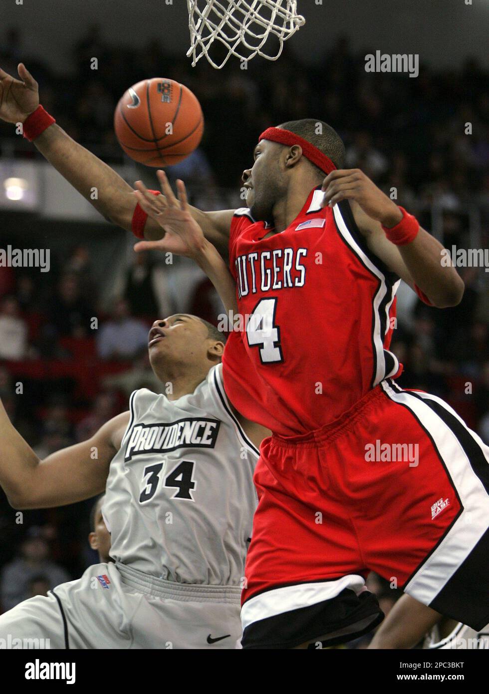 Rutgers' Adrian Hill (4) and Providence's Jonathan Kale try to pull in ...