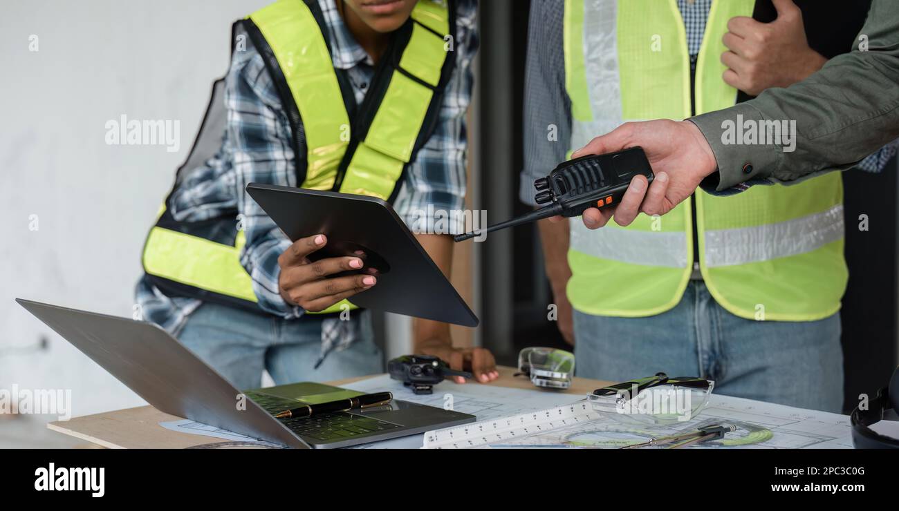 engineer working in office with blueprints , walkie talkie, tablet ...
