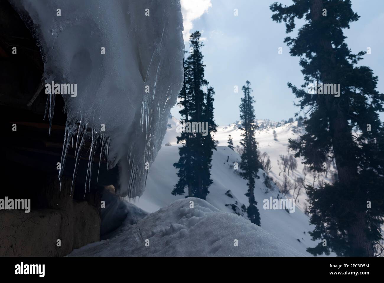 Icicles hang outside a mud house during a sunny day at Lidwas at an ...