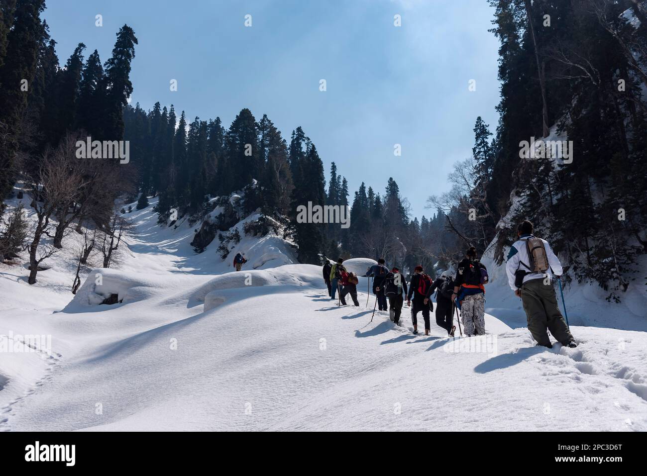 Trekkers are seen enroute their way through a snow covered mountain ...