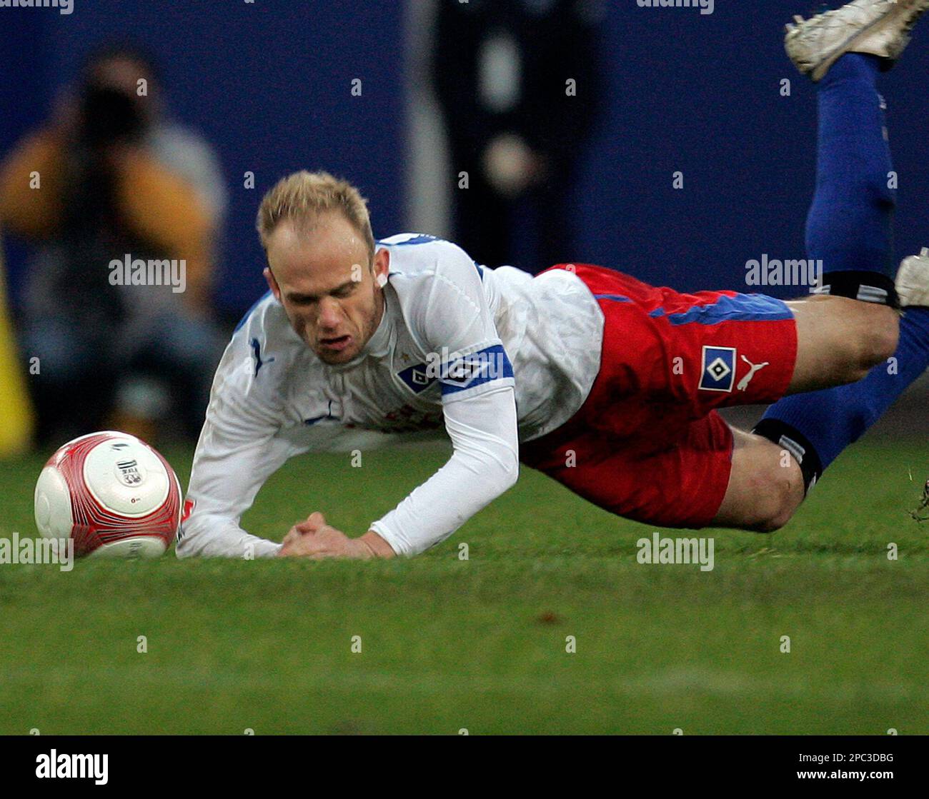 Hamburg's David Jarolim from Czech Republic lies on the pitch during a ...