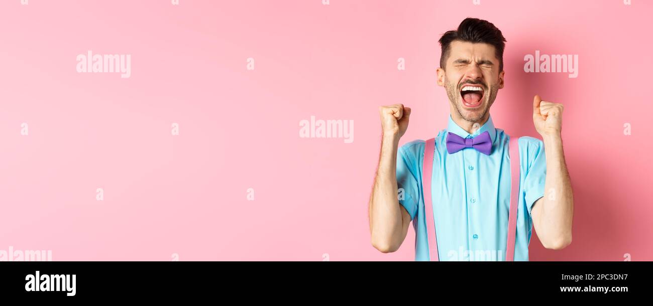 Relieved man shouting from happiness and joy, scream yes with closed ...