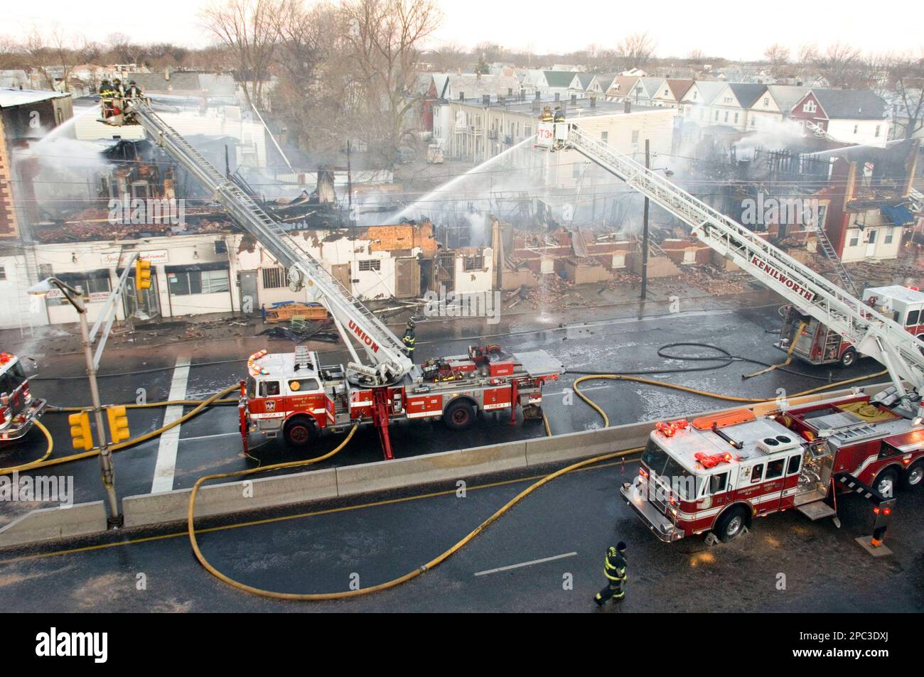 Firefighters from several fire deparments fight a fire that destroyed a ...