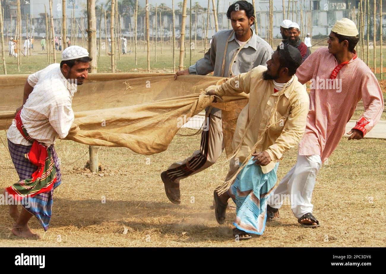 Bangladeshi Muslim volunteers work on a jute tent in preparation for ...