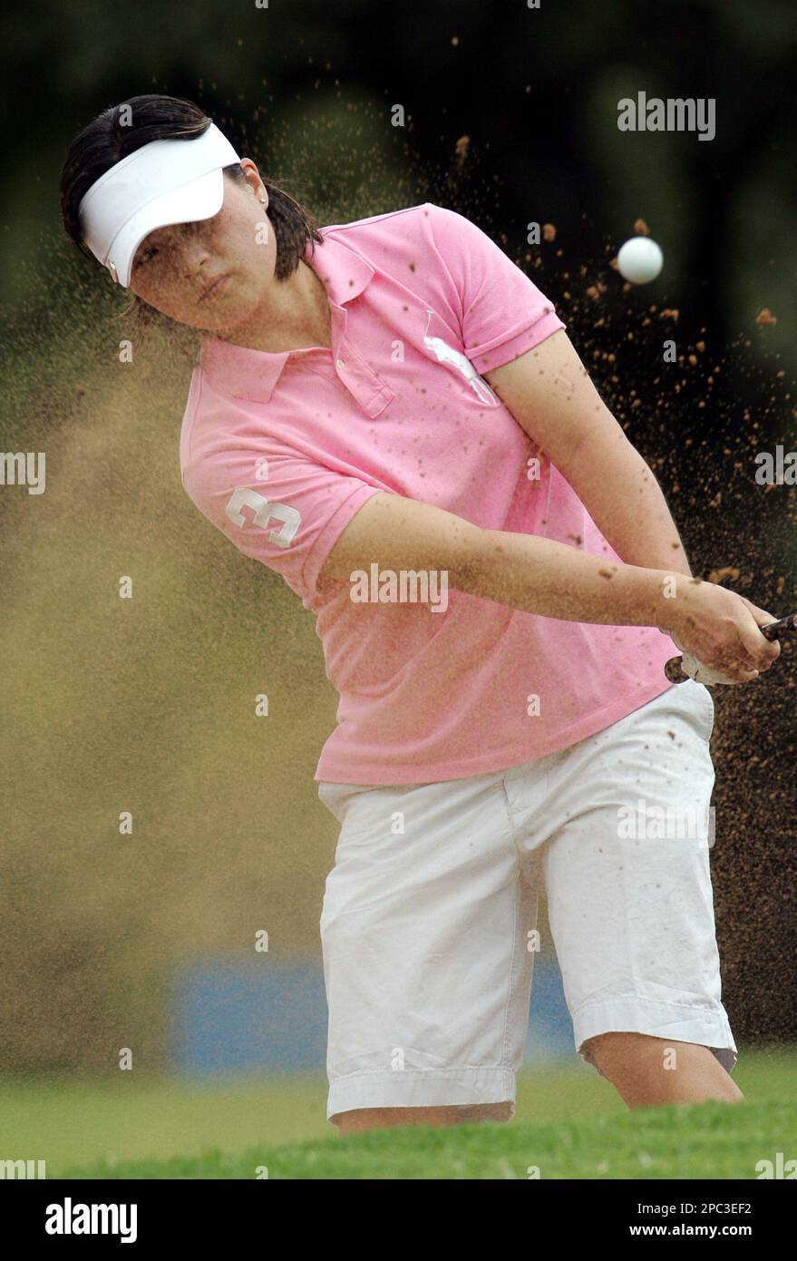 Taiwan's golfer Yu Ping Lin blasts the ball out of a bunker next to the ...