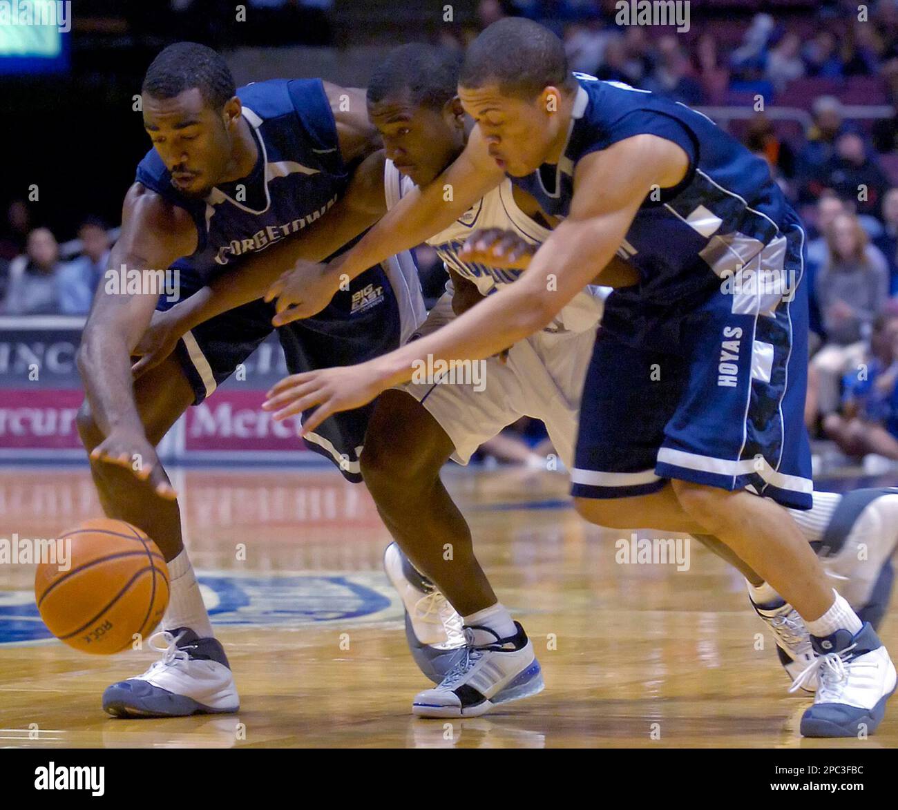 Georgetown's DaJuan Summers, left, and Jonathan Wallace, right, squeeze ...