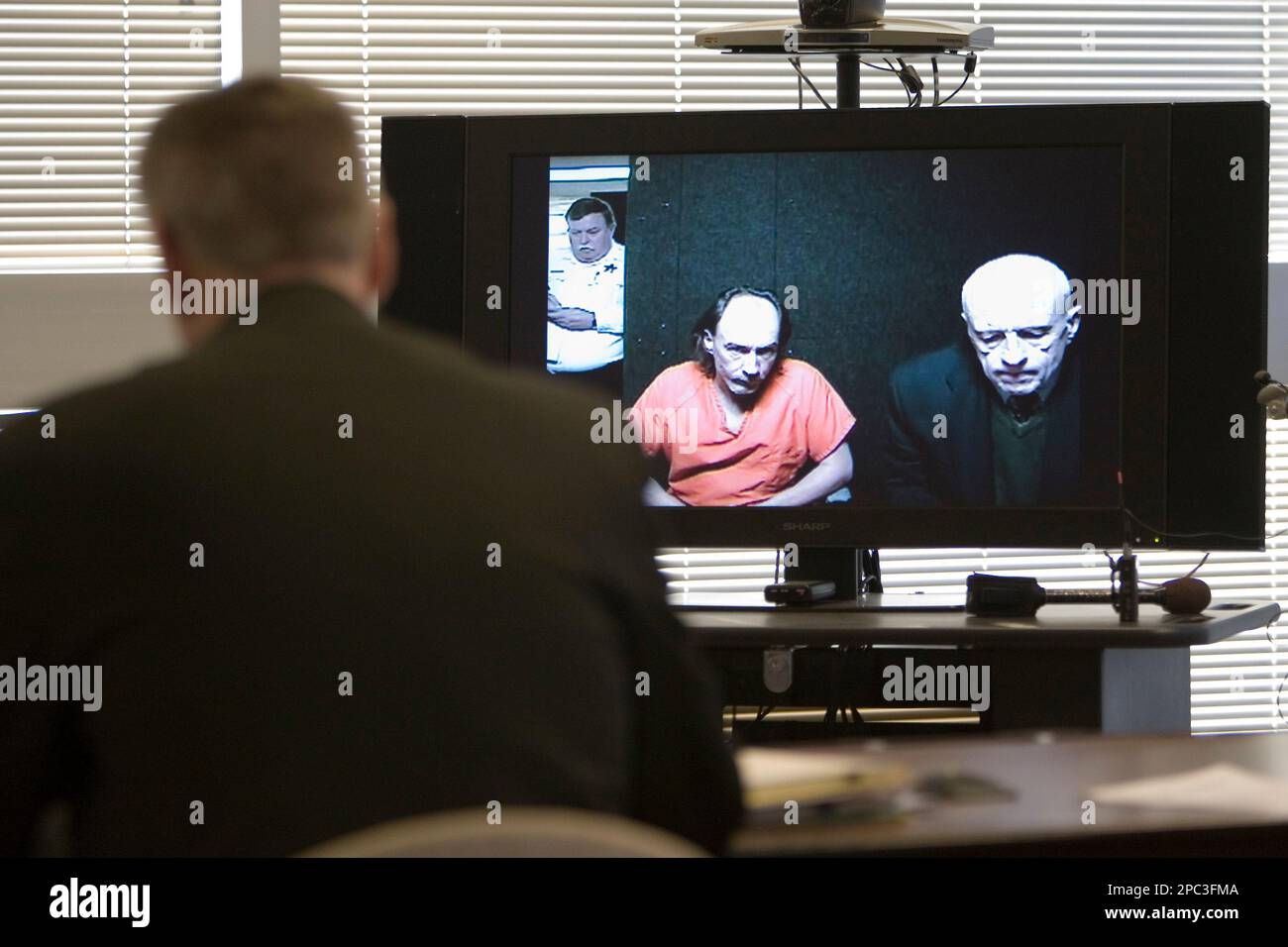 James C. Koepp, left on the video screen, appears with his attorney ...