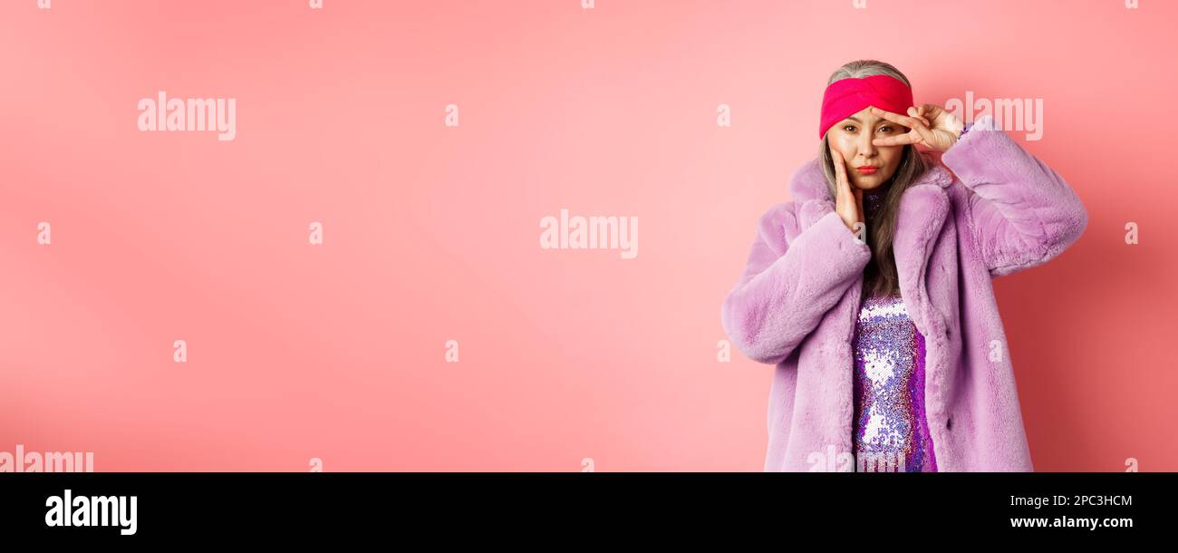 Fashion and shopping. Beautiful asian senior woman in stylish faux fur ...