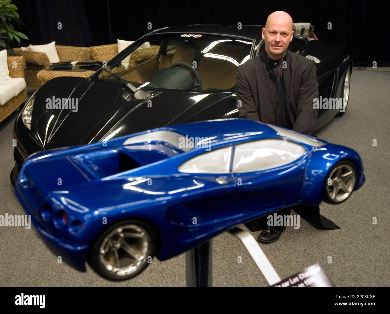 Designer Luc Chartrand stands between a scale model and a prototype of ...