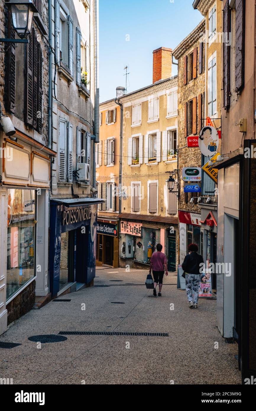 Rue de Deume, a narrow street with shops and colorful ochre coated ...