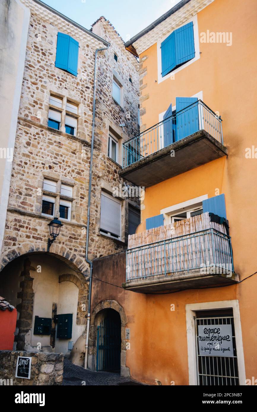 Medieval stone house next to a colorful ochre parge coated house in the ...